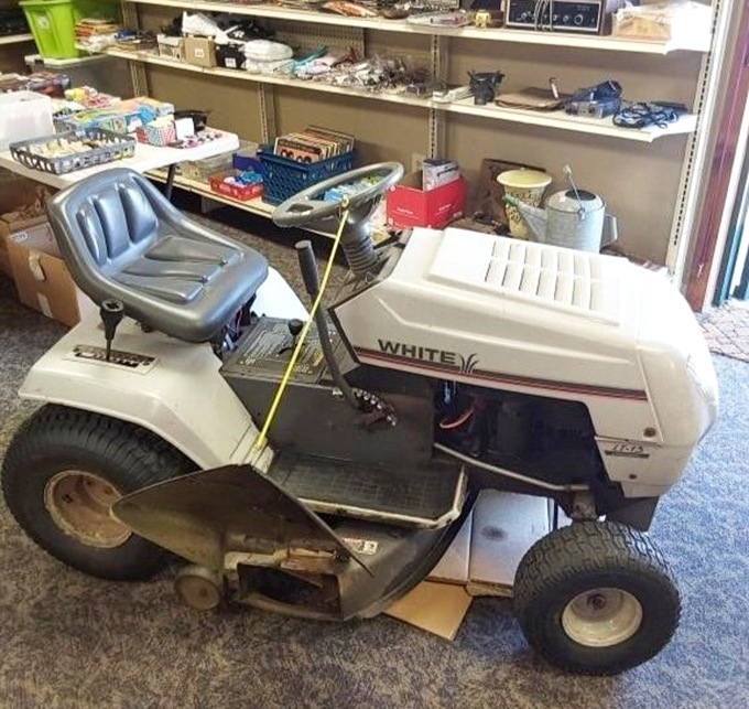 Suburban chariot of yesteryear. This White lawn tractor has trimmed more grass than a barber on prom night.