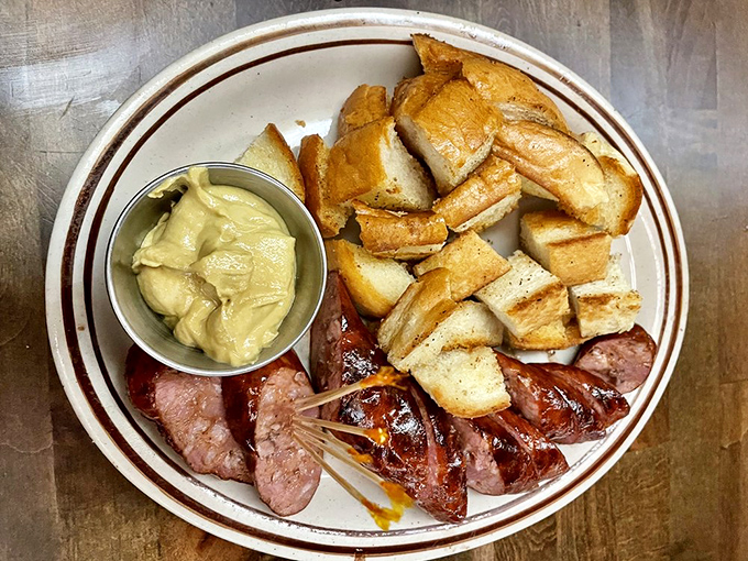 A loaded baked potato that's dressed for success alongside perfectly grilled sausage. This plate doesn't need fancy garnishes to make its point.