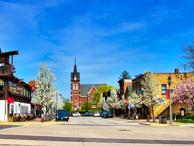 Spring transforms Main Street into a celebration of blossoms and blue skies, with the church steeple providing that perfect European village silhouette.