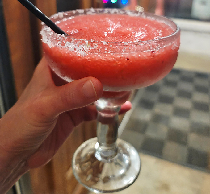 A frozen margarita with a salt rim sitting pretty&mdash;because sometimes pizza night calls for a little liquid celebration.