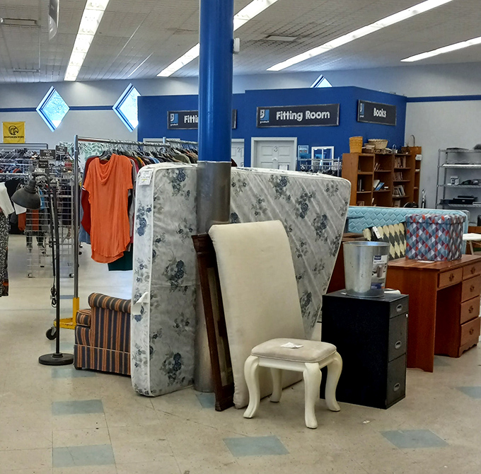 Fitting rooms and mattresses share space in this corner of the store. That small white stool could be perfect for someone's vanity.