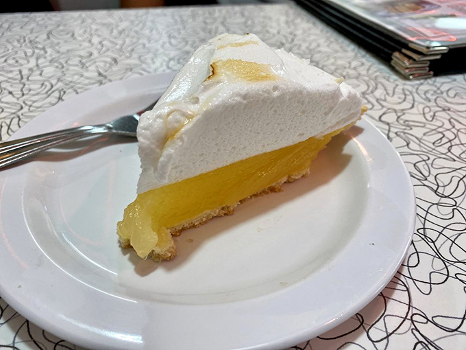 Lemon meringue pie with clouds of white fluff so perfect it looks like it's posing for its driver's license photo.