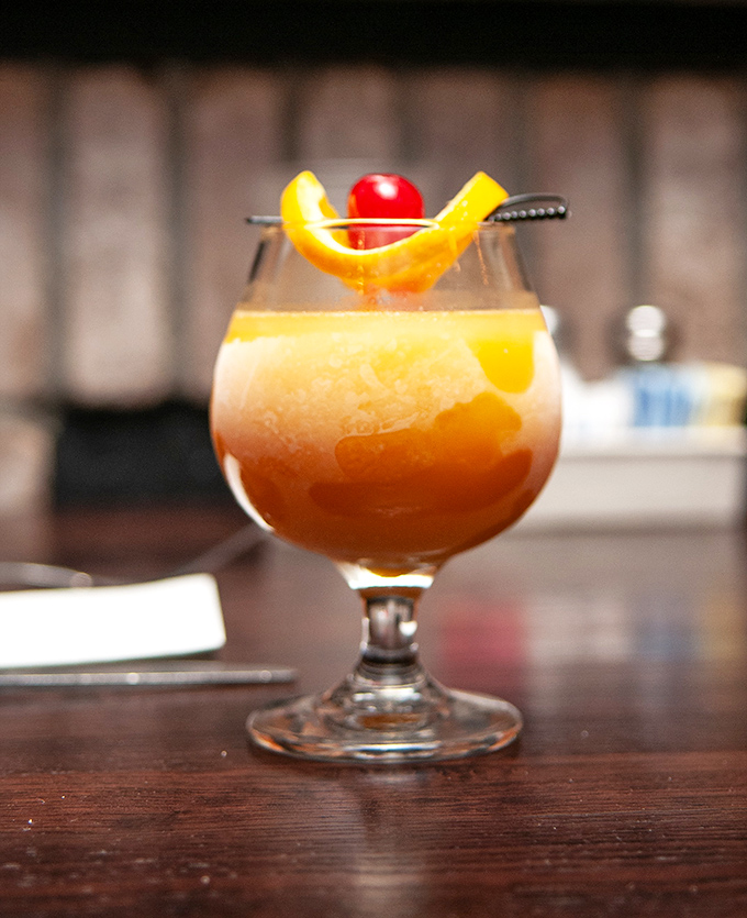 This isn't just a cocktail&mdash;it's liquid sunshine in a glass, garnished with citrus and cherry for that perfect "I deserve this" moment.
