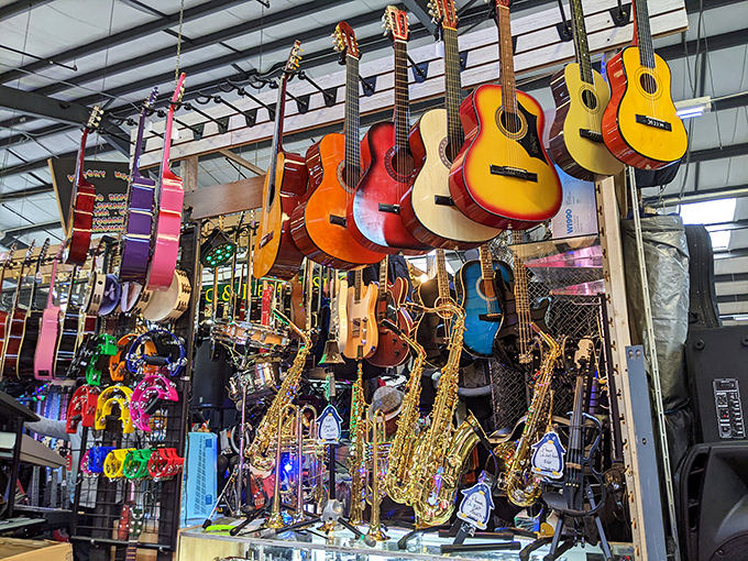 A symphony of strings hangs in suspended animation, each guitar and saxophone waiting for the right hands to bring them to life.
