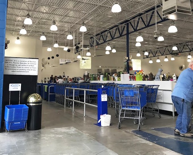 Blue carts stand at attention near the checkout, awaiting their next mission to transport newfound treasures to happy homes.