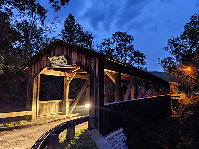 As twilight descends, Knapp's Bridge takes on a mysterious quality. The illuminated entrance beckons like a portal to Pennsylvania's pastoral past.