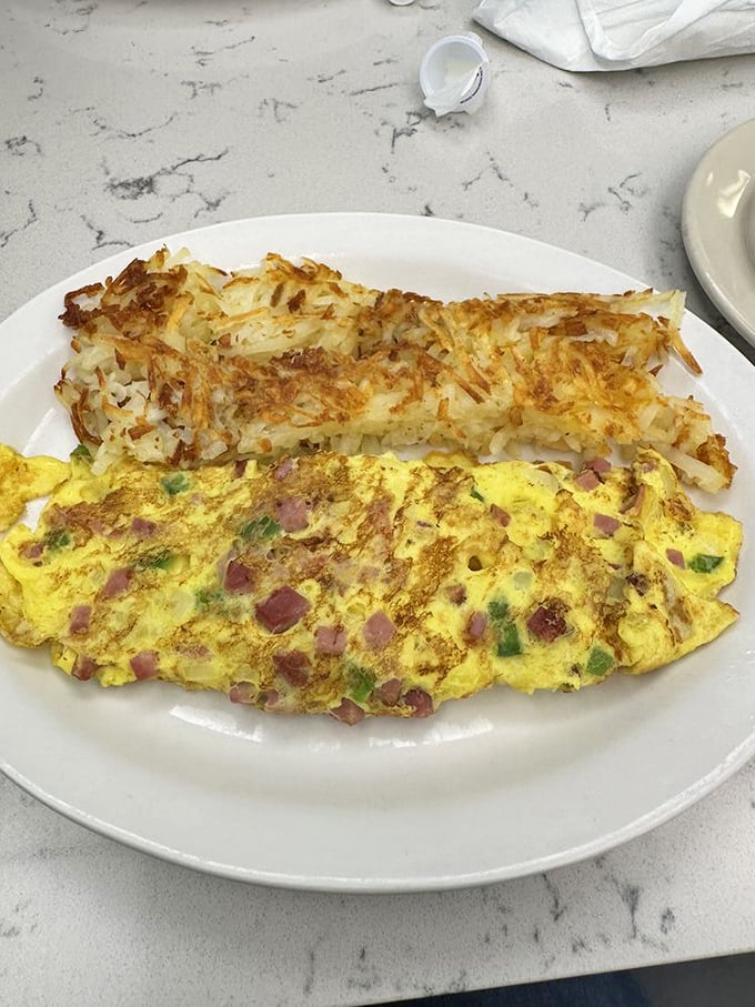 Breakfast harmony achieved: a Western omelet meets hash browns that are essentially potato lace&mdash;crispy, golden, and impossible to stop eating.