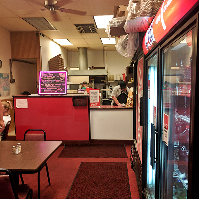 Where pizza magic happens. That red counter has witnessed more food joy than most five-star restaurants could ever dream of.