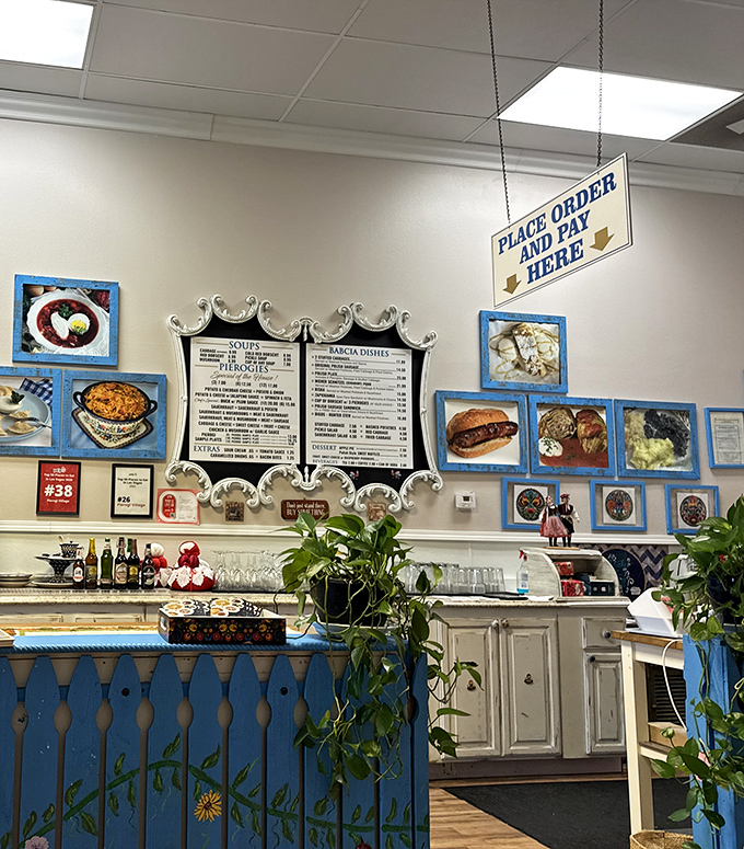 The counter where dumpling dreams come true – framed food photos tempt you while blue folk-art details add authentic charm.