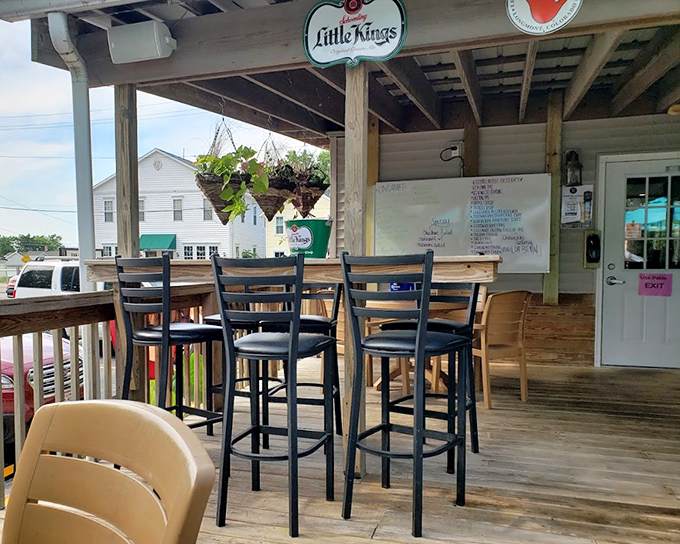 This casual outdoor seating area at "Little Kings" offers a laid-back vibe where conversations flow as easily as the drinks and lake views add natural ambiance.