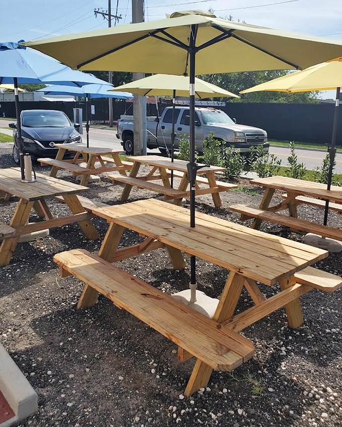 The outdoor seating area, where picnic tables under yellow umbrellas invite you to savor smoky treasures in the Florida sunshine.