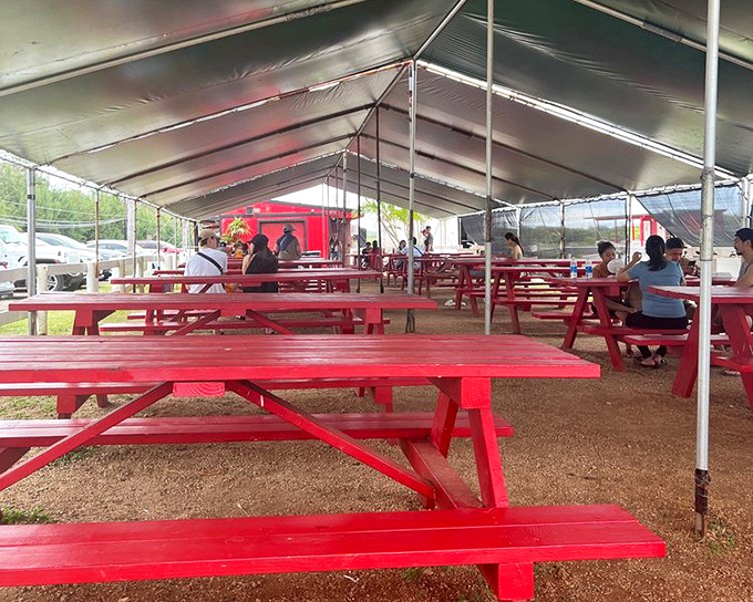 Red picnic tables under a tent&mdash;no white tablecloths needed when the food is this good and the Hawaiian breeze is your ambiance.