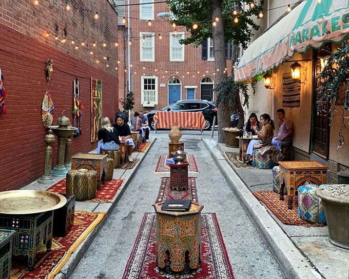 The alleyway transforms into an outdoor Moroccan salon, where colorful rugs and brass tables create an urban oasis for pre-dinner mint tea and conversation.