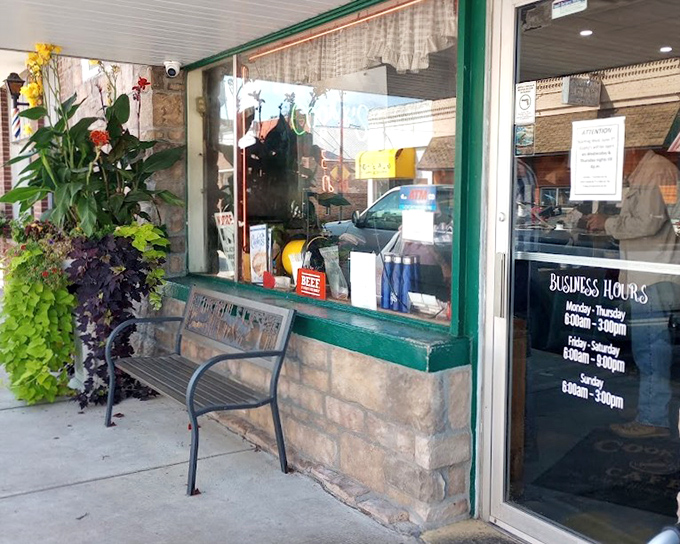 Plants frame the entrance like nature's own welcome committee, while the business hours promise plenty of opportunities for pie-based happiness.