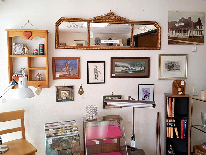 A gallery wall that's part museum, part time capsule. That gilded mirror has reflected more fashion trends than Vogue magazine.