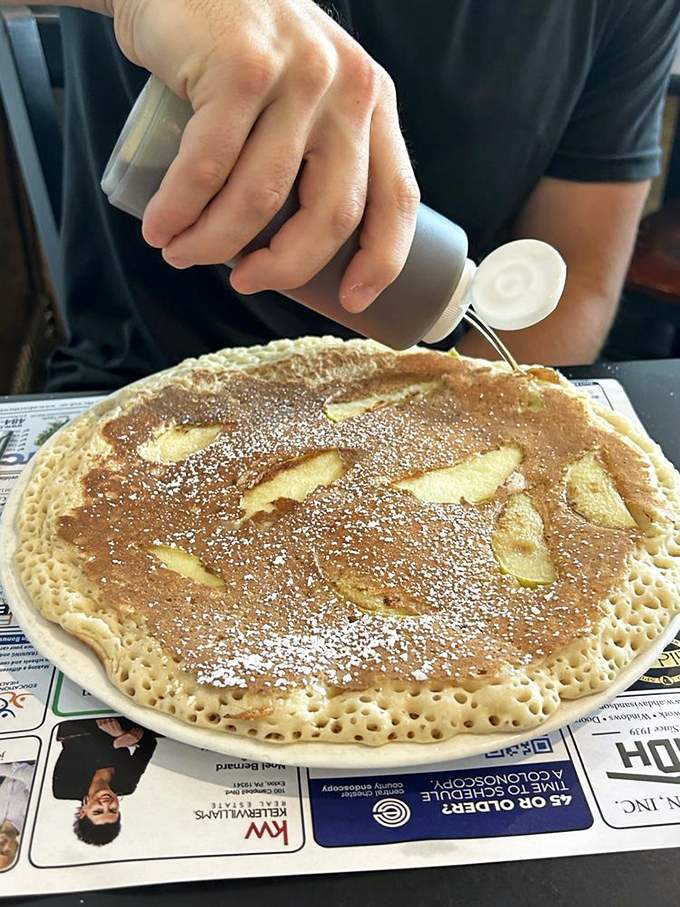 Watching powdered sugar snow onto a pancake studded with apple slices. Some moments in life are truly sacred&mdash;this is definitely one of them.
