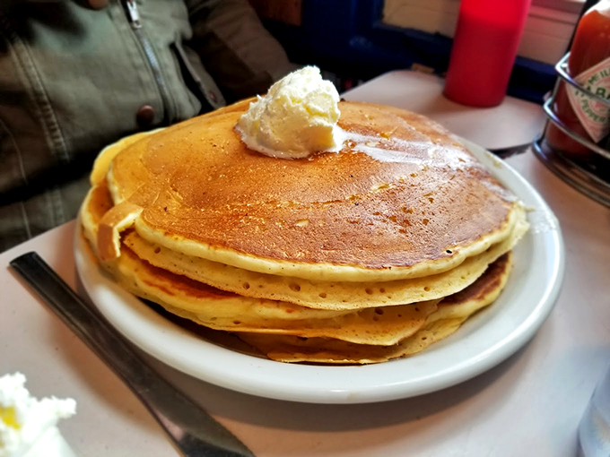 Pancakes stacked higher than Wisconsin snowdrifts. That melting butter creates golden rivers of deliciousness that demand maple syrup tributaries.
