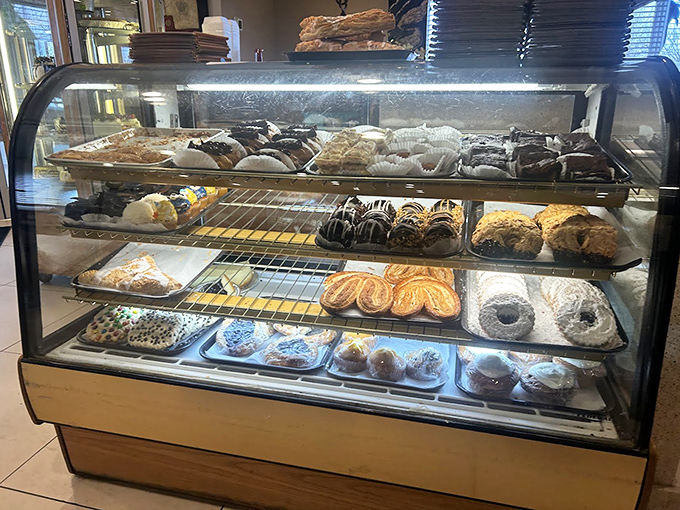 The pastry case&mdash;a glass-enclosed museum of baked temptations. Each shelf displays edible art that makes waiting for a table almost pleasurable.