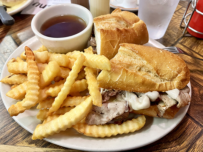 The French dip sandwich&mdash;where beef and bread find their higher purpose. Those fries aren't just a side; they're crispy golden co-stars in this comfort food production.
