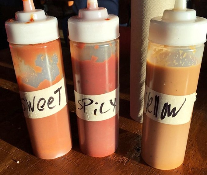 Three sauces labeled simply as "Sweet," "Spicy," and "Yellow" &ndash; because when you're this confident in your barbecue, you don't need fancy names.