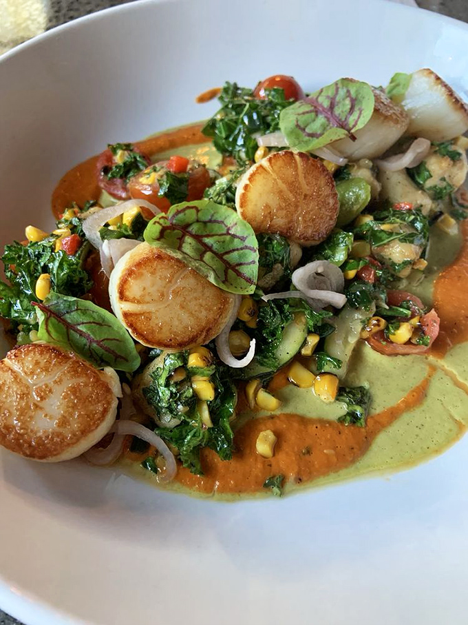 These scallops aren't just seared&mdash;they're transformed into buttery pucks of ocean sweetness, swimming in a colorful sauce duet.