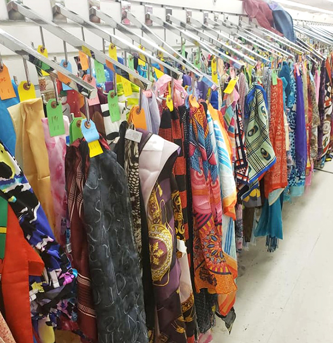 A kaleidoscope of scarves that would make Iris Apfel proud, each vibrant pattern telling tales of fashion trends across the decades.