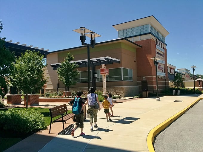 Family shoppers march toward retail adventure, bags in hand, like explorers who've discovered a new continent of bargains.