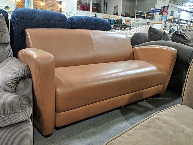 This leather sofa has stories to tell, but thankfully, it's keeping them to itself while offering you a comfy place to create new ones.