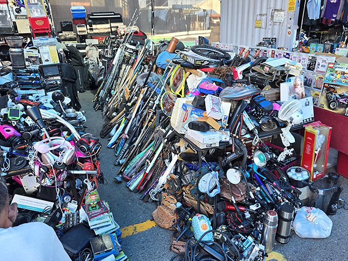 A chaotic treasure trove of sporting goods and household items. One person's clutter becomes another's essential find in this organized chaos.