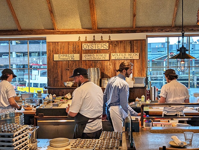 The oyster station—where skilled hands transform bivalves into briny treasures. These folks could probably shuck in their sleep.