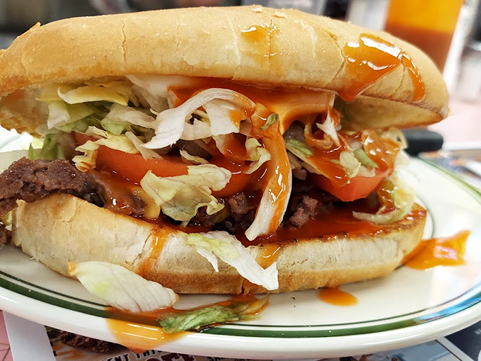 This isn't just a burger &ndash; it's a gravity-defying tower of beef, fresh toppings, and sauce that requires both hands and possibly a bib commitment.