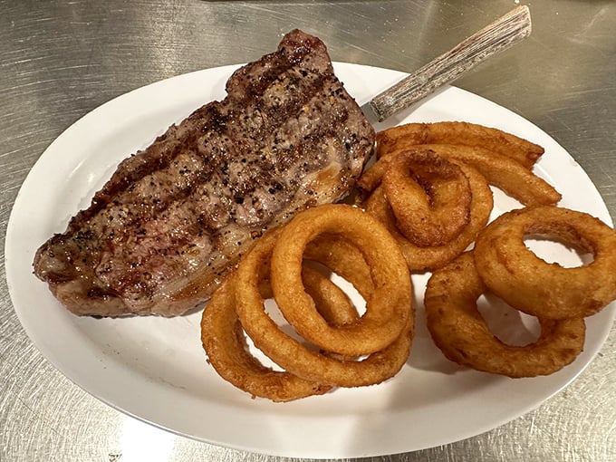 A perfectly seared steak with golden onion rings&mdash;proof that Lou's dinner game is just as strong as its breakfast reputation.