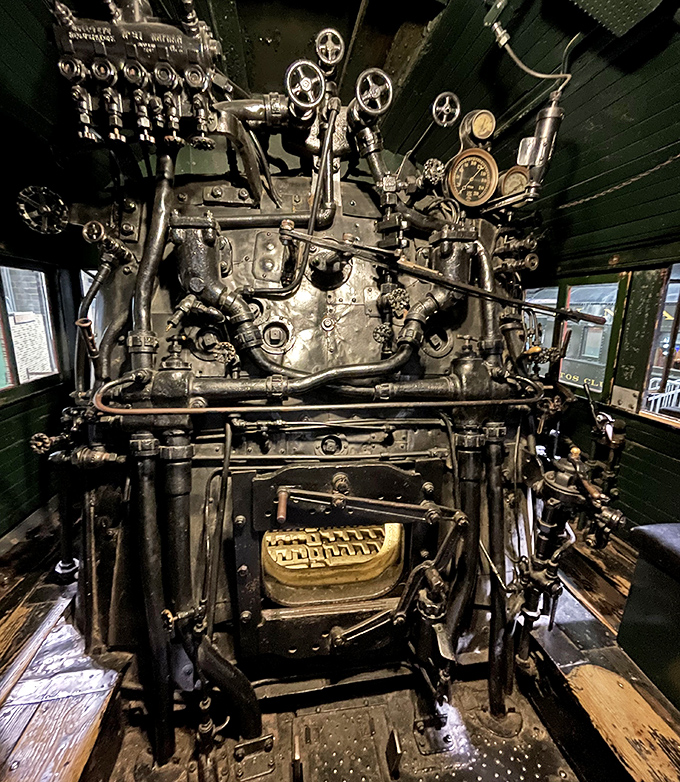 The locomotive cab interior reveals a mechanical symphony of valves, gauges, and levers that required an engineer's expert touch.
