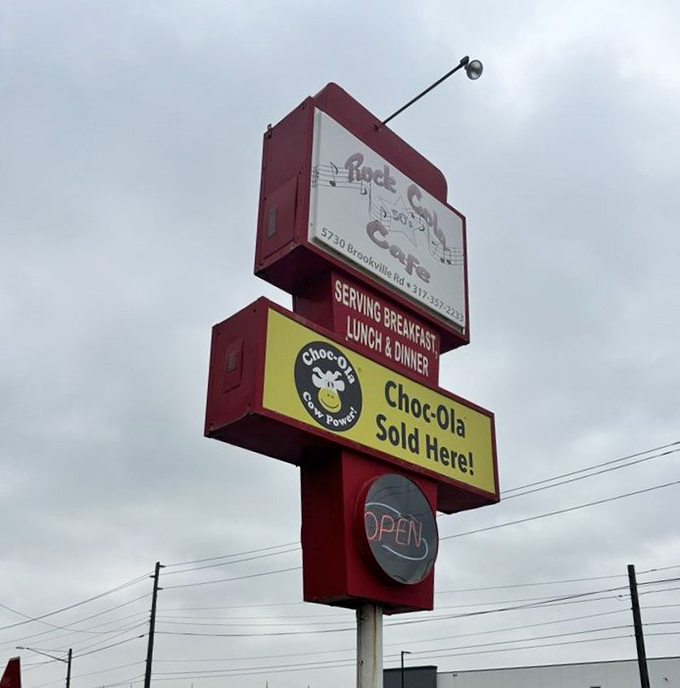 The roadside sign announces "Breakfast, Lunch & Dinner" like a promise rather than a menu&mdash;with a bonus alert that Choc-Ola, Indiana's beloved chocolate drink, awaits inside.