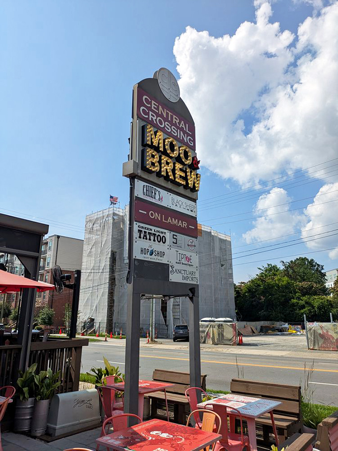 The Central Crossing sign stands tall, a colorful landmark guiding hungry travelers to their burger destiny like a modern-day North Star.