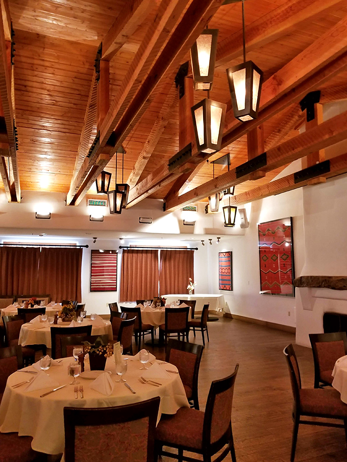 Soaring wooden ceilings and lantern lighting create the perfect stage for culinary drama. Even empty tables here tell stories of meals past.