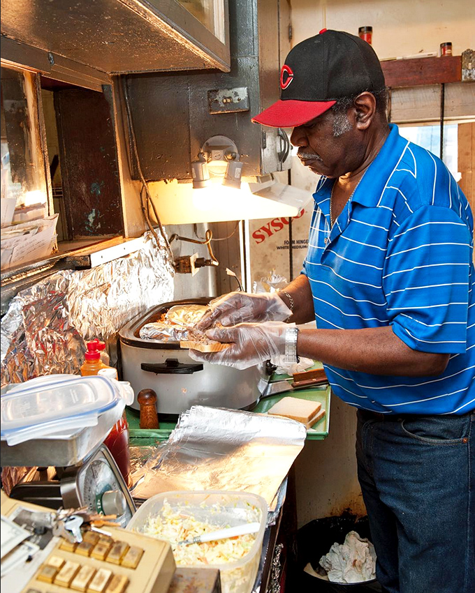 Craftsmanship in motion &ndash; skilled hands preparing each sandwich with the precision and care that comes from generations of barbecue wisdom.