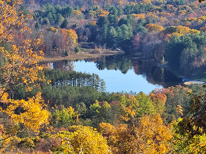 Autumn explodes in technicolor glory, reflecting in waters so still you can't tell where reality ends and mirror begins.