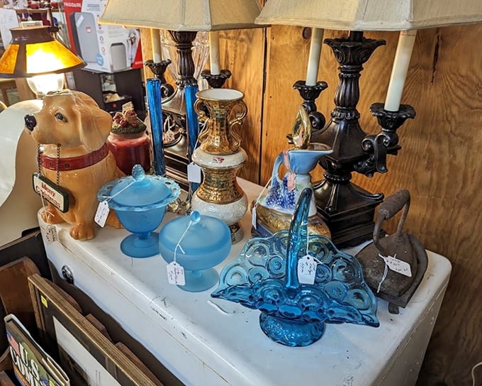 Blue glass and vintage candelabras share space with a ceramic dog&mdash;a delightful jumble that perfectly captures the "you never know what you'll find" spirit.