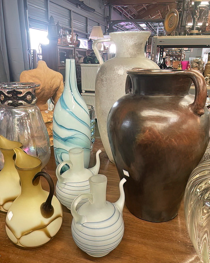 Vases that span decades and design movements stand shoulder to shoulder. That swirled blue piece would make even bodega flowers look like a professional arrangement.