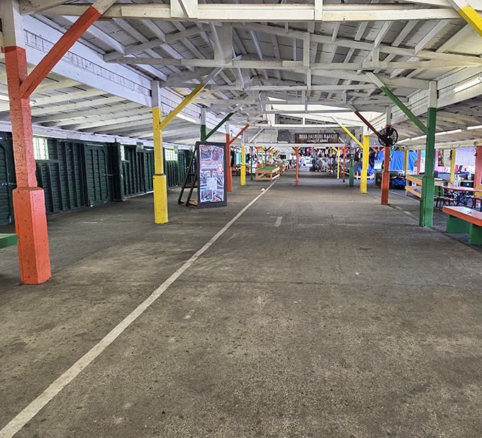 The calm before the shopping storm. Colorful support beams stand like sentinels, waiting for vendors to transform this space into bargain bedlam.