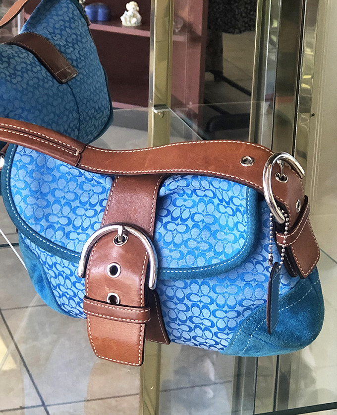 The designer handbag section: where patient shoppers are rewarded with authentic finds. This blue Coach beauty has plenty of life left.
