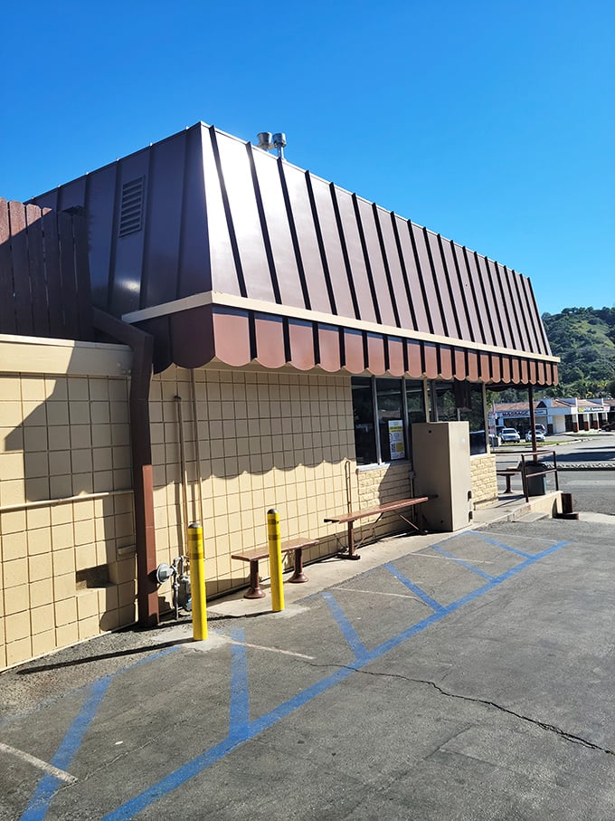 The exterior view reveals the shop's humble charm&mdash;brown awnings against beige walls, where culinary magic happens without pretension or fanfare.
