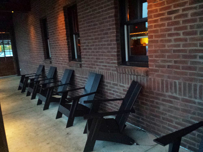 The waiting area's reclaimed wood paneling and vintage beer signs set the tone before you even sit down &ndash; comfort and craftsmanship await inside.