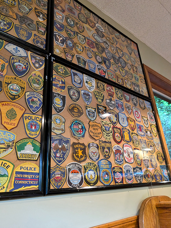 The wall of police and fire department patches tells stories of first responders who've found comfort here between calls. Diner d&eacute;cor with meaning.