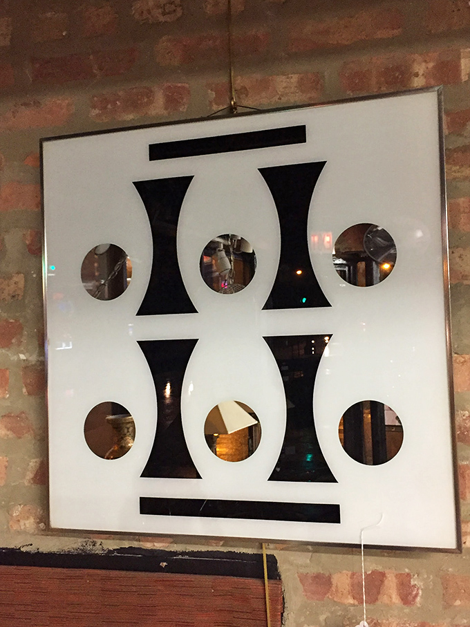 Geometric wall art that could have hung in a 1960s corporate lobby now waits for its second act in someone's carefully curated living room.