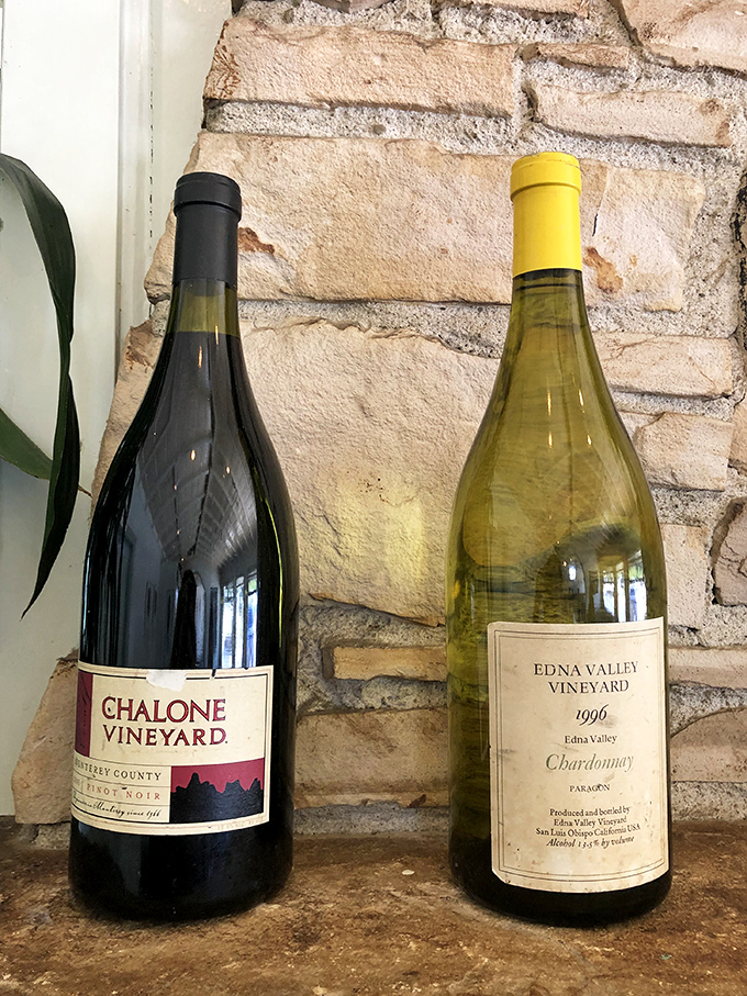 Wine bottles that patiently wait their turn to enhance your seafood experience&mdash;like supporting actors who know exactly when to step into the spotlight.