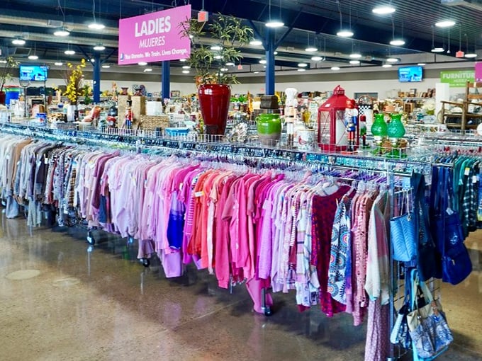 The ladies' section explodes with color like a sartorial rainbow, each hue representing someone's former fashion statement now awaiting its second act.