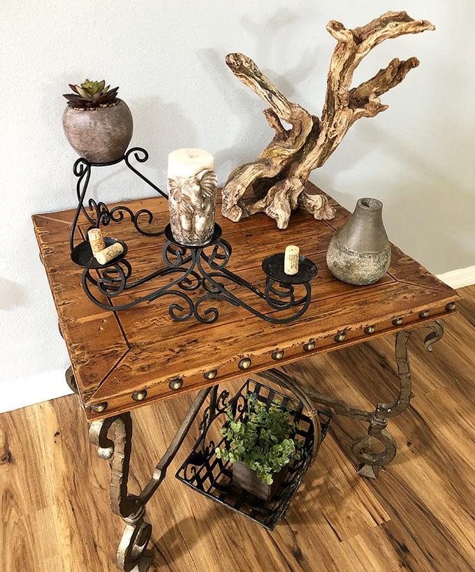 This rustic accent table with wrought iron details isn't just furniture&mdash;it's a conversation piece with stories to tell and succulents to display.