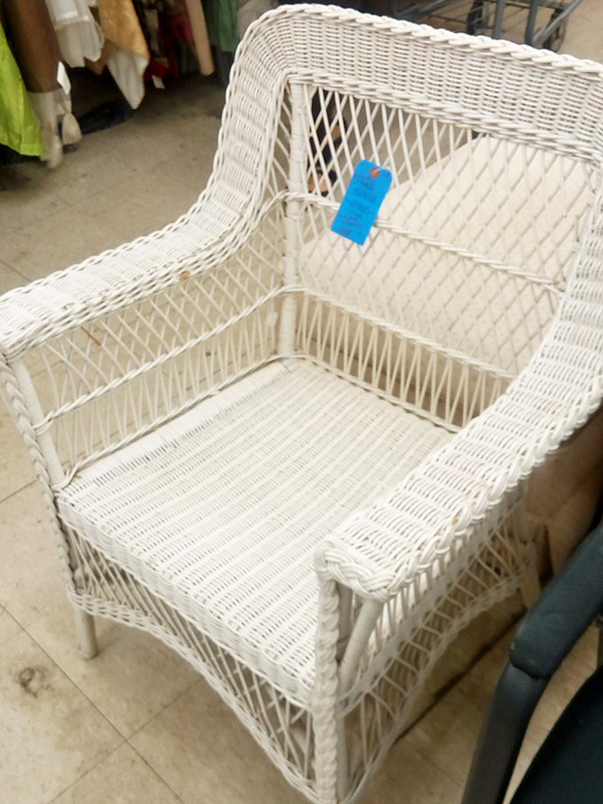 This white wicker chair isn't just seating – it's a summer reading nook, a front porch sentinel, a character in your home's ongoing story.